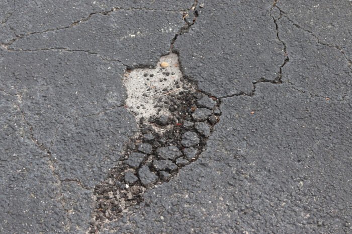 What are the main causes of raveling? | One Stop Asphalt